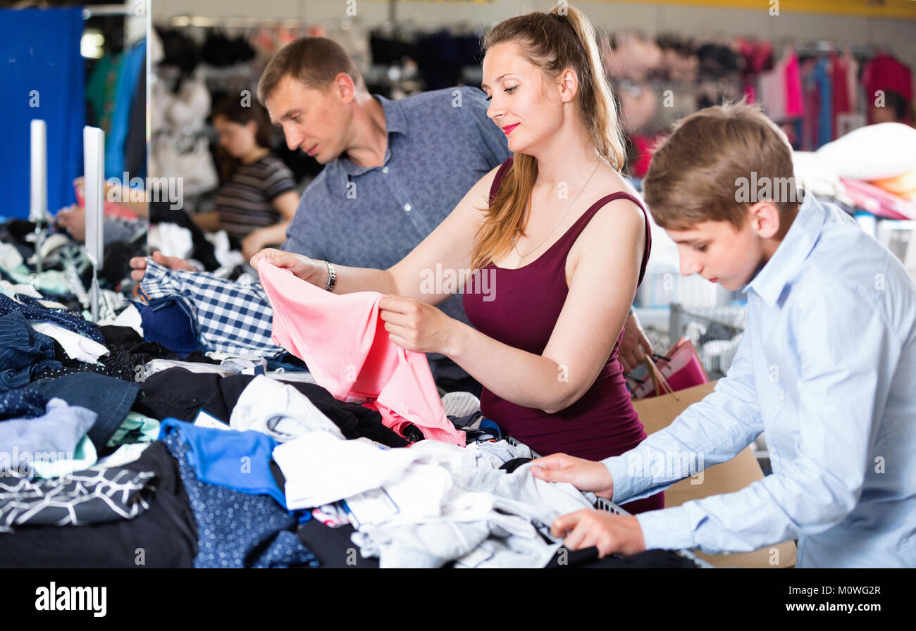 Happy cheerful positive three people of any ages shopping at the outlet ...