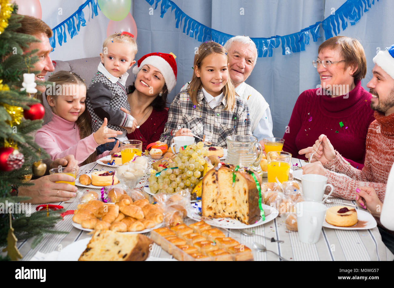 Adults with children are engaging in dialog during celebration ...