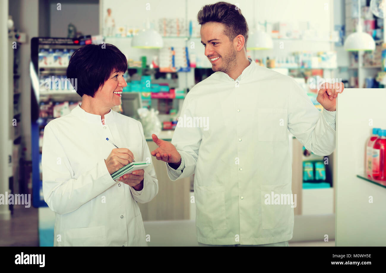 Cheerful pharmacist and pharmacy technician posing in drugstore Stock ...