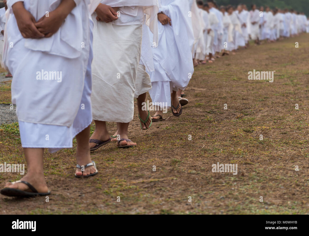 Closeup the foot of Many Buddhist nuns girls line in white suit walking ...