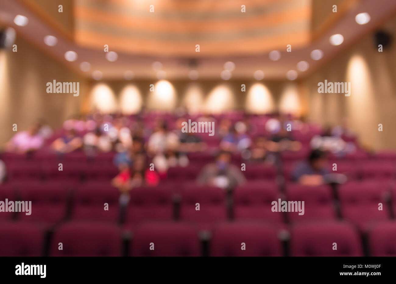 Abstract blurred photo of conference hall or meeting room with attendee ...