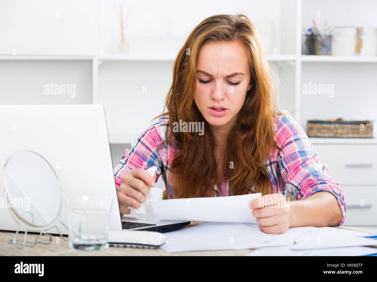 girl in trouble working with laptop at room table Stock Photo - Alamy