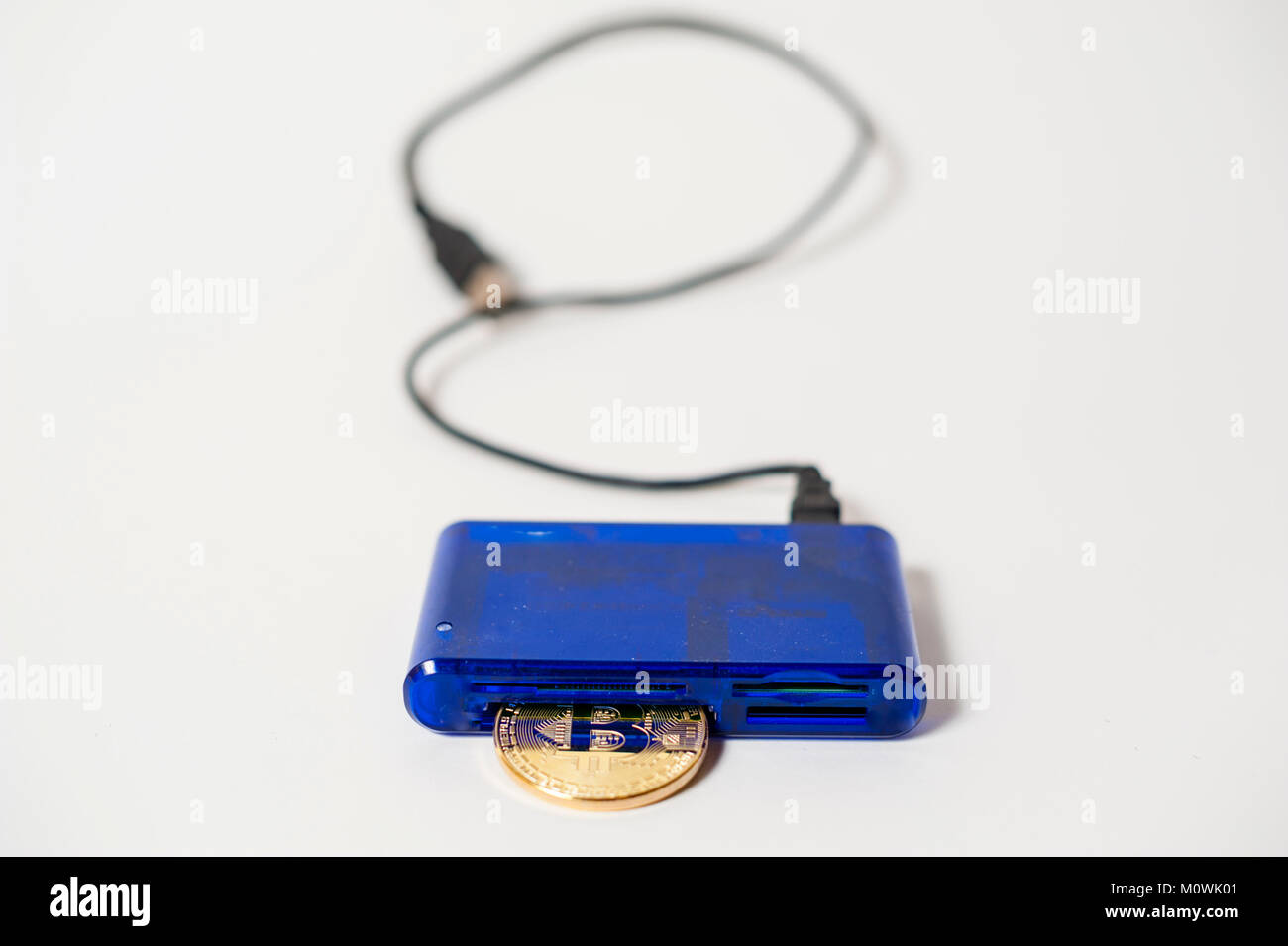 bitcoin electronic coin inside a digital card reader, white background ...