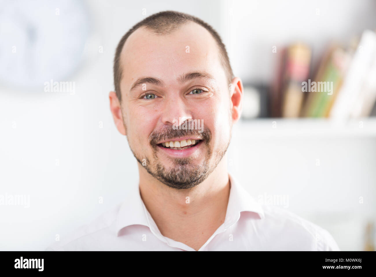 Portrait of smiling young successful worker at his office Stock Photo ...