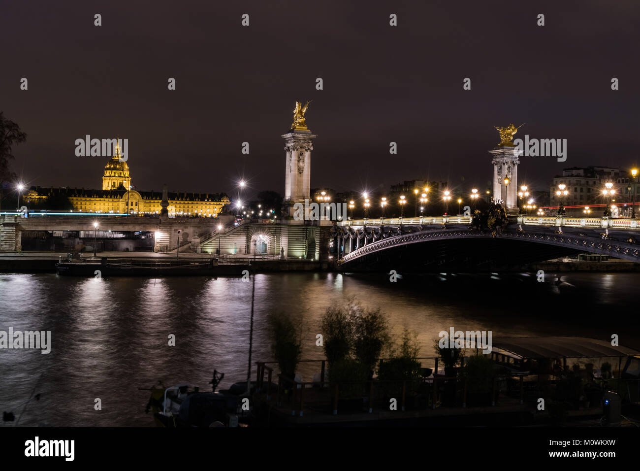 Alexander II bridge and Invalides Museum at night in Paris Stock Photo ...