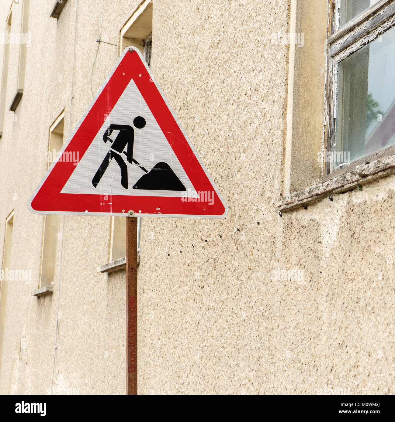 Construction site sign in front of a house wall with windows Stock ...