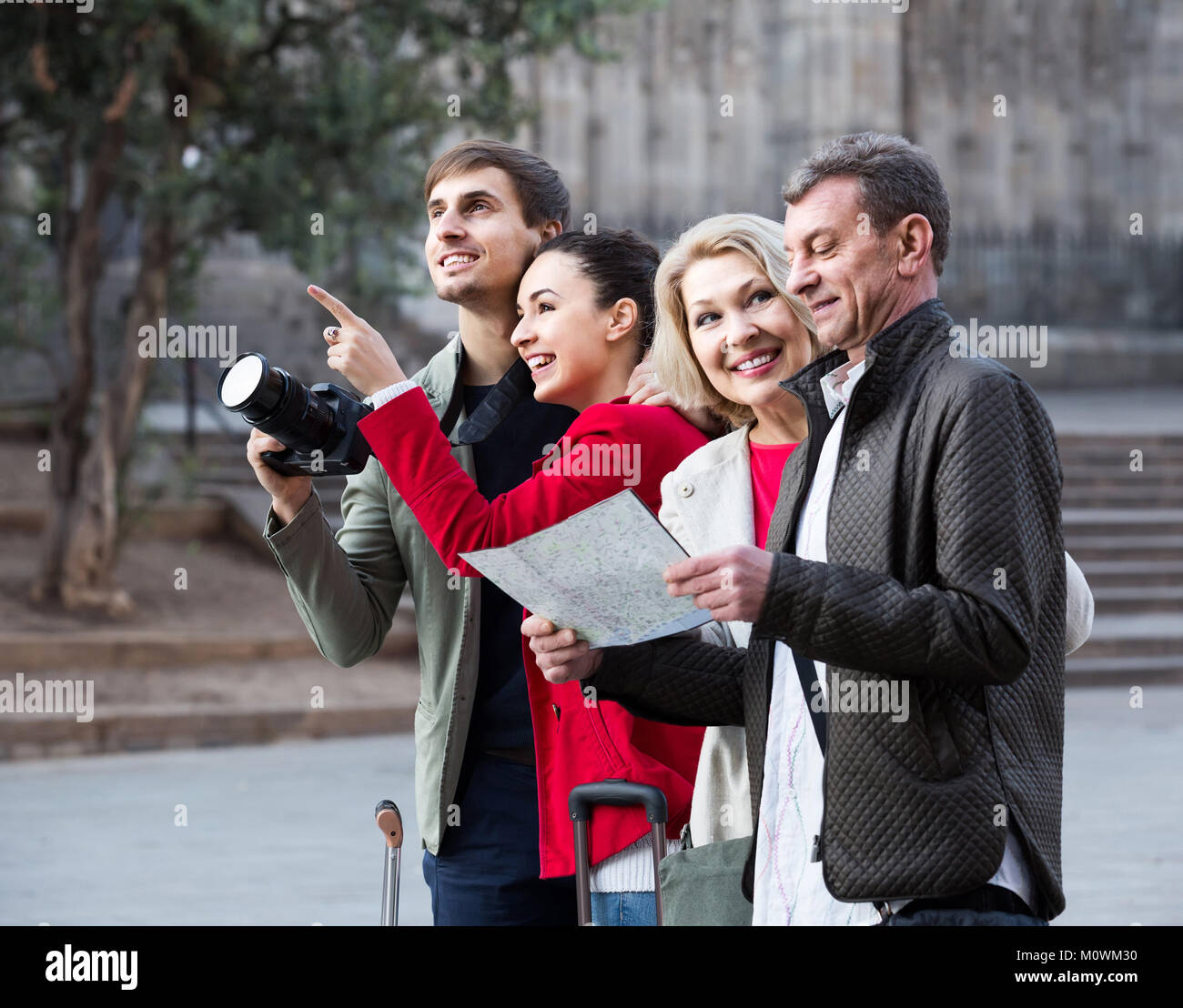 Portrait of russian tourists with map and baggage seeing the sights in ...