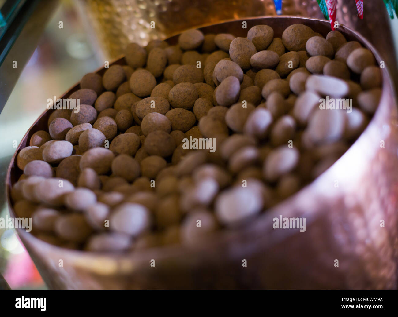 Container with cacao covered chocolate pellets in tea-room Stock Photo ...