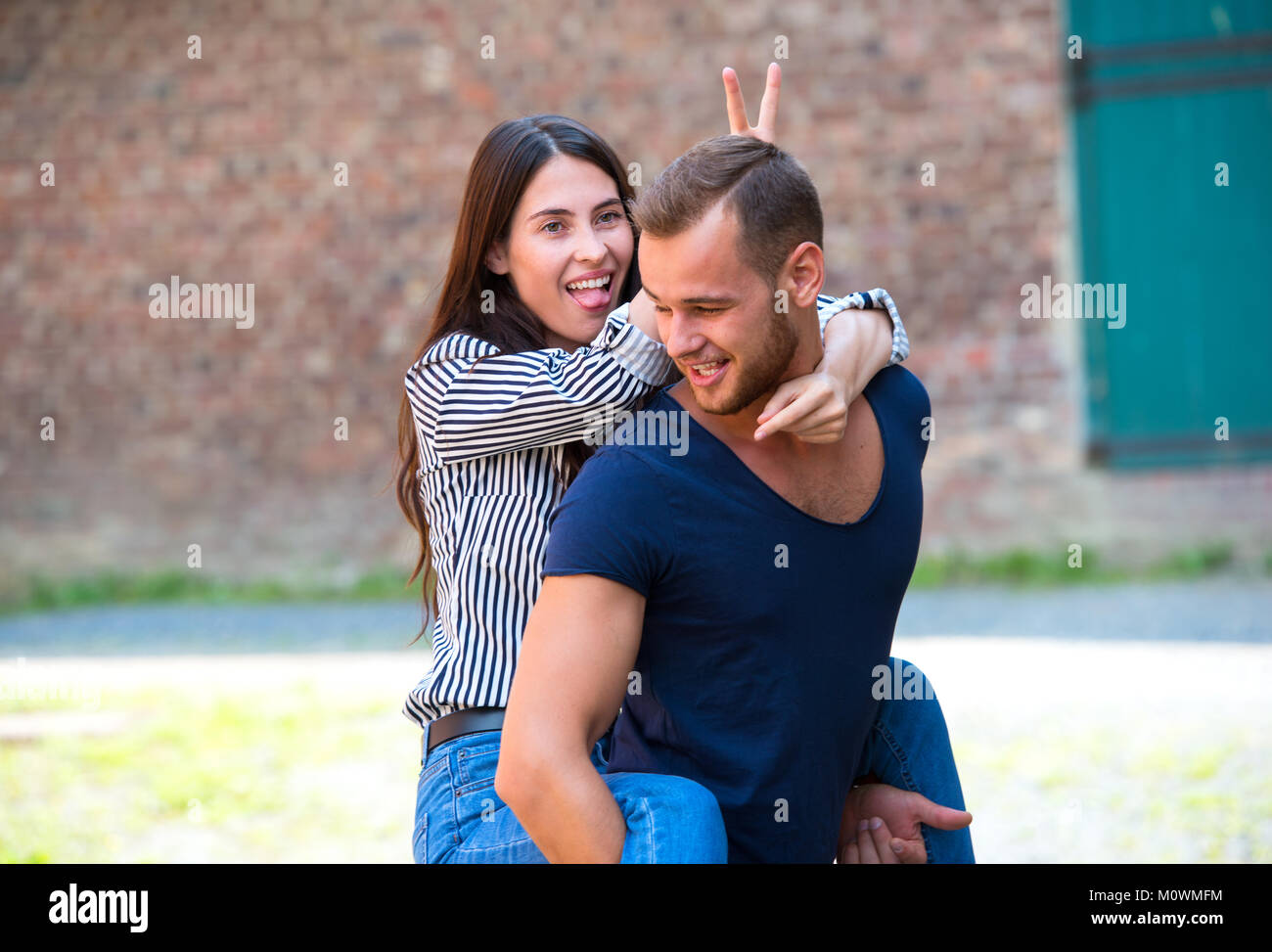 Outdoor portrait of romantic young couple making silly faces Stock ...