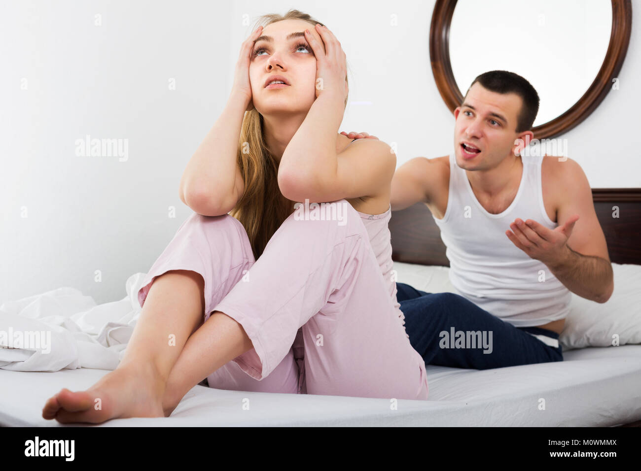 Two unhappy young partners having domestic quarrel in bedroom Stock ...