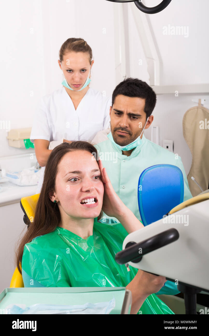 Scared american woman patient treating at the dental hospital Stock ...