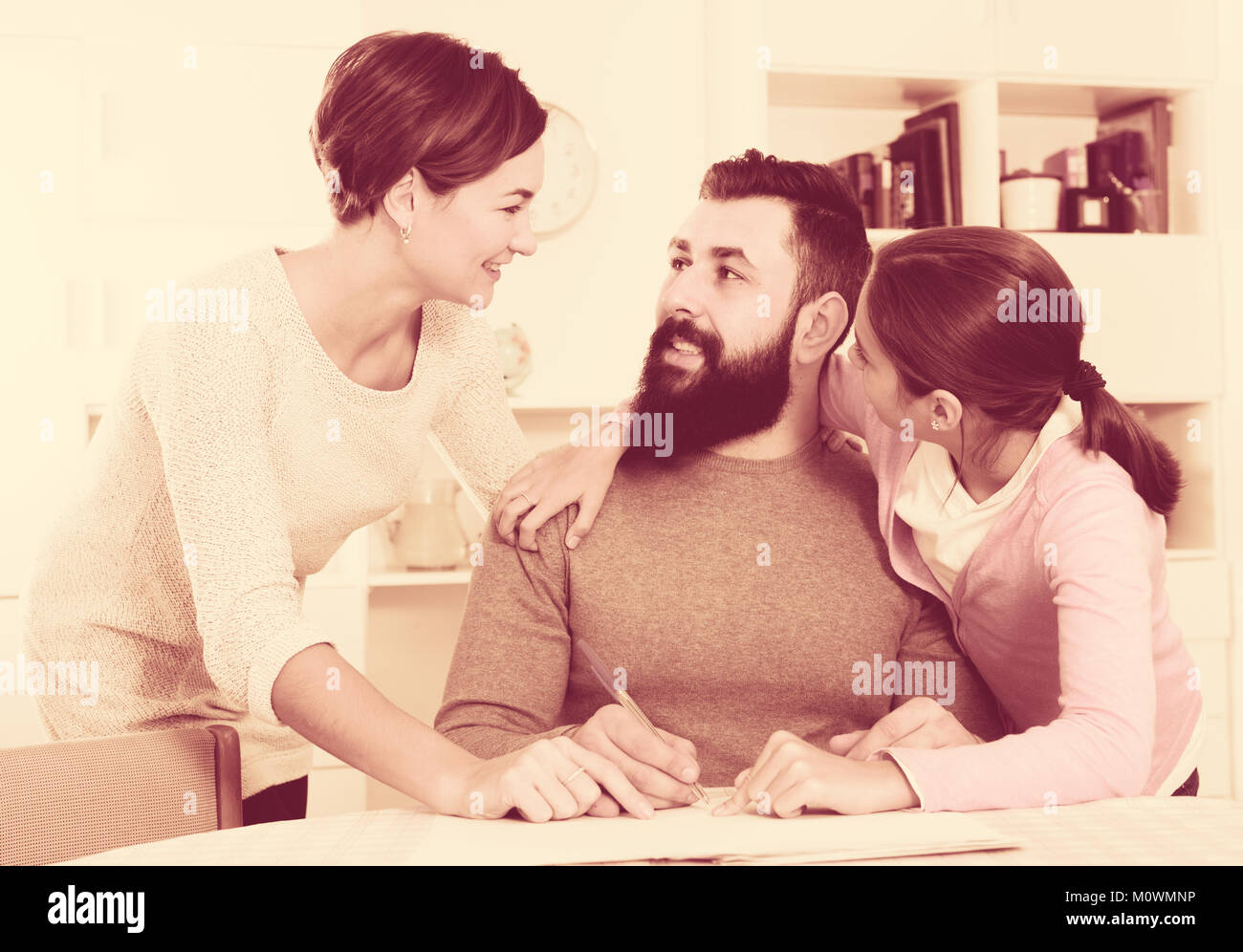 Young parents signing papers for new house with their daughter Stock ...