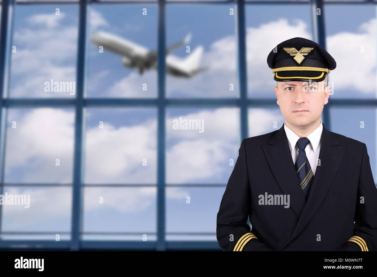 Captain in uniform at the airport Stock Photo - Alamy