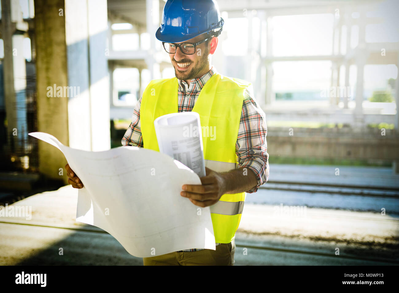 Picture of construction site engineer looking at plan Stock Photo - Alamy