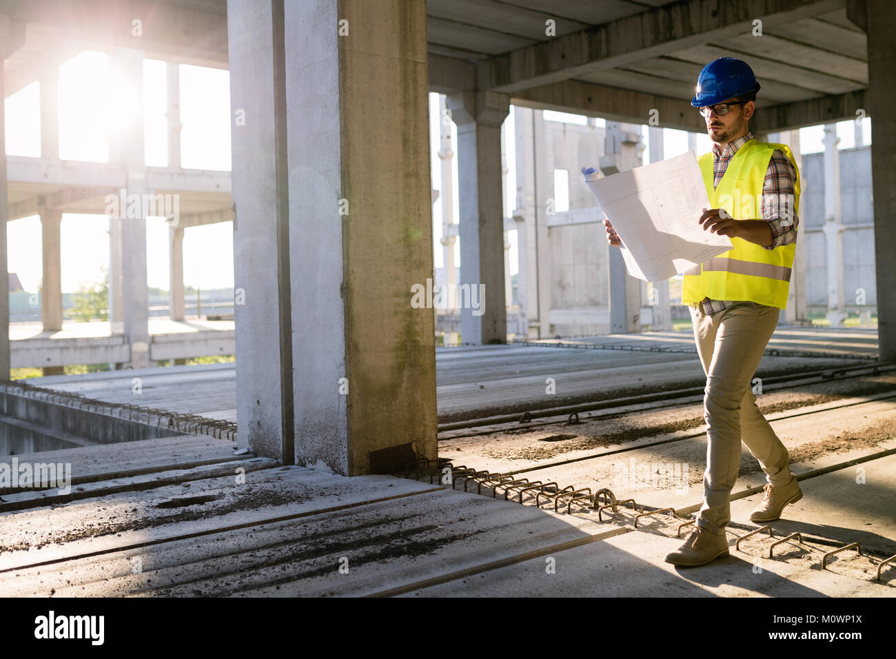 Picture of construction site engineer looking at plan Stock Photo - Alamy