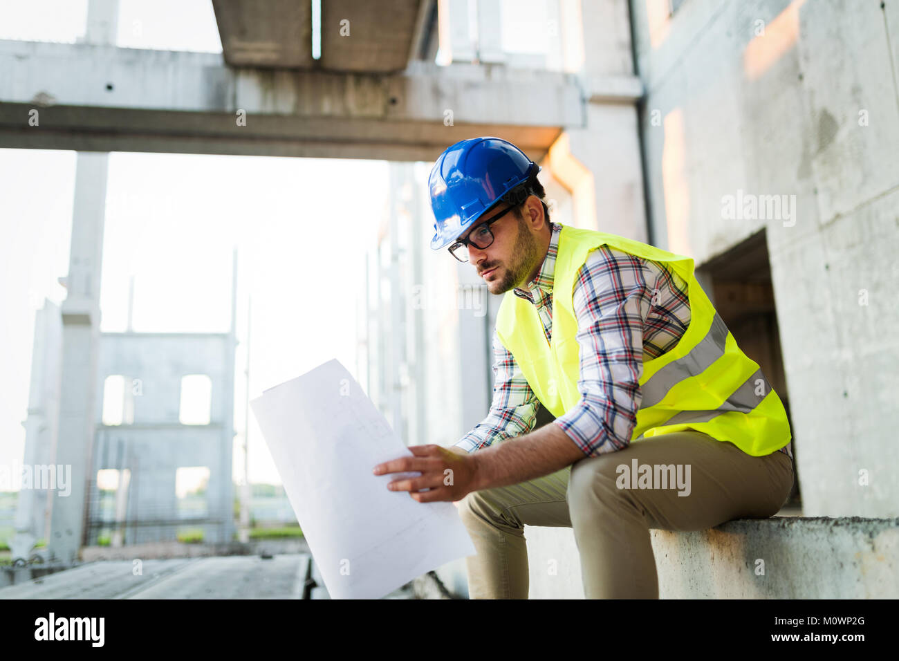 Picture of construction site engineer looking at plan Stock Photo - Alamy