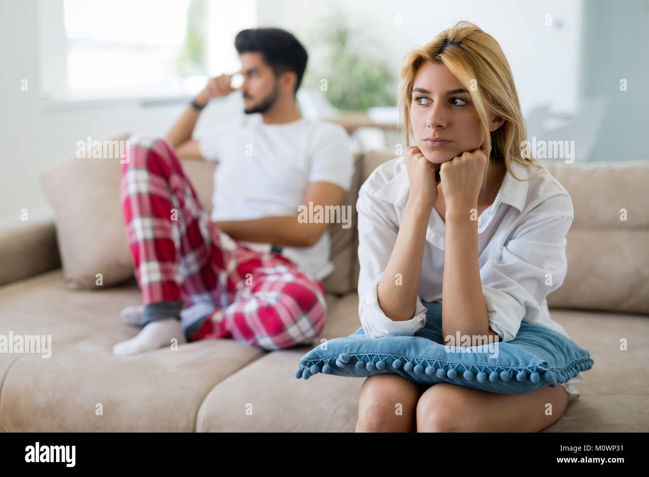 Worried couple having problems in bedroom Stock Photo - Alamy
