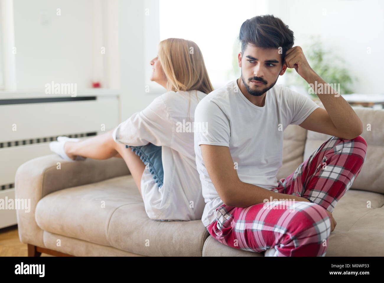 Worried couple having problems in bedroom Stock Photo - Alamy