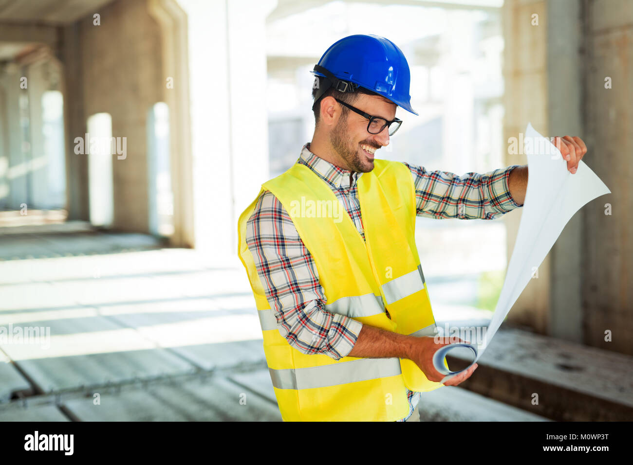 Picture of construction site engineer looking at plan Stock Photo - Alamy
