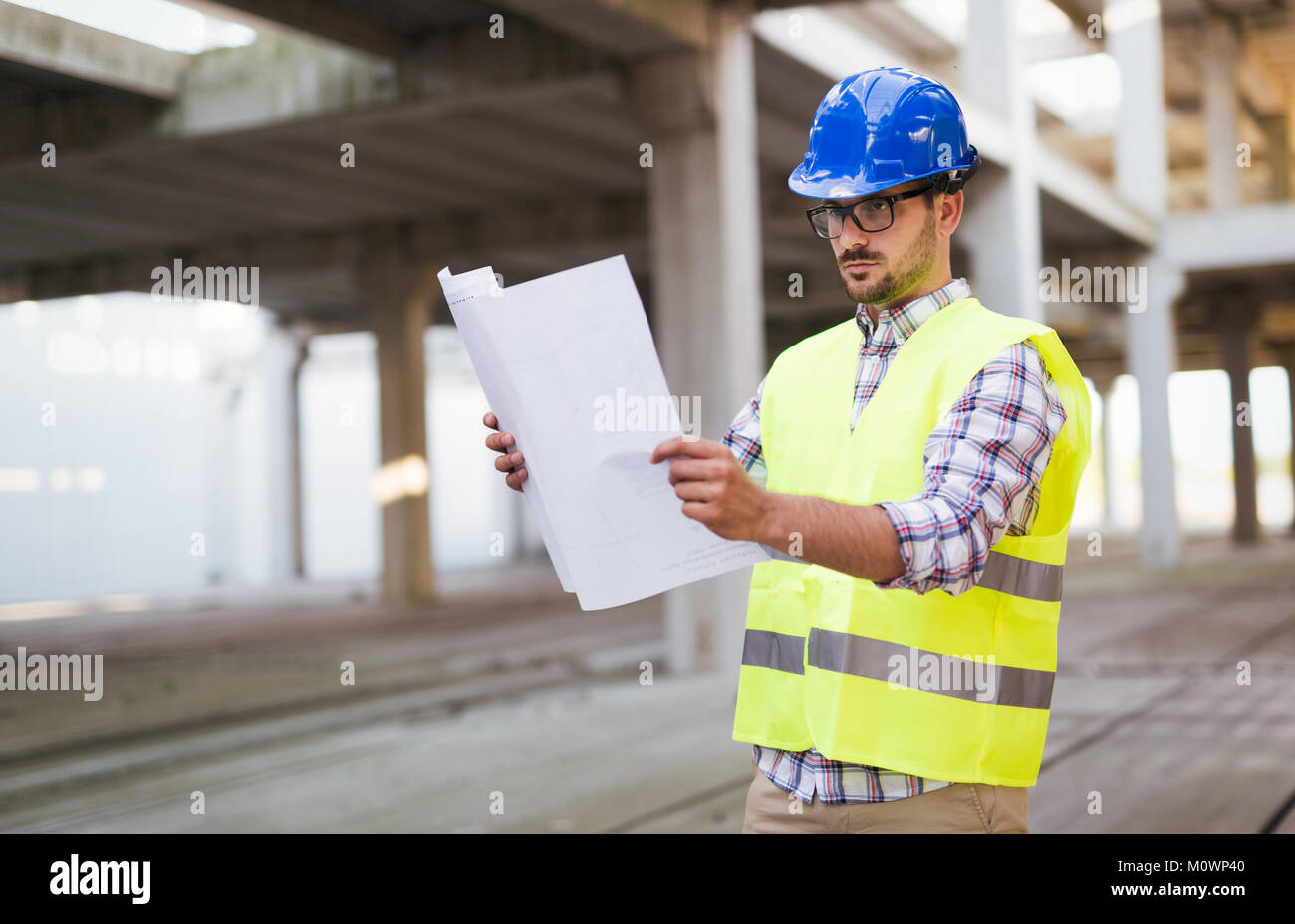 Picture of construction site engineer looking at plan Stock Photo - Alamy