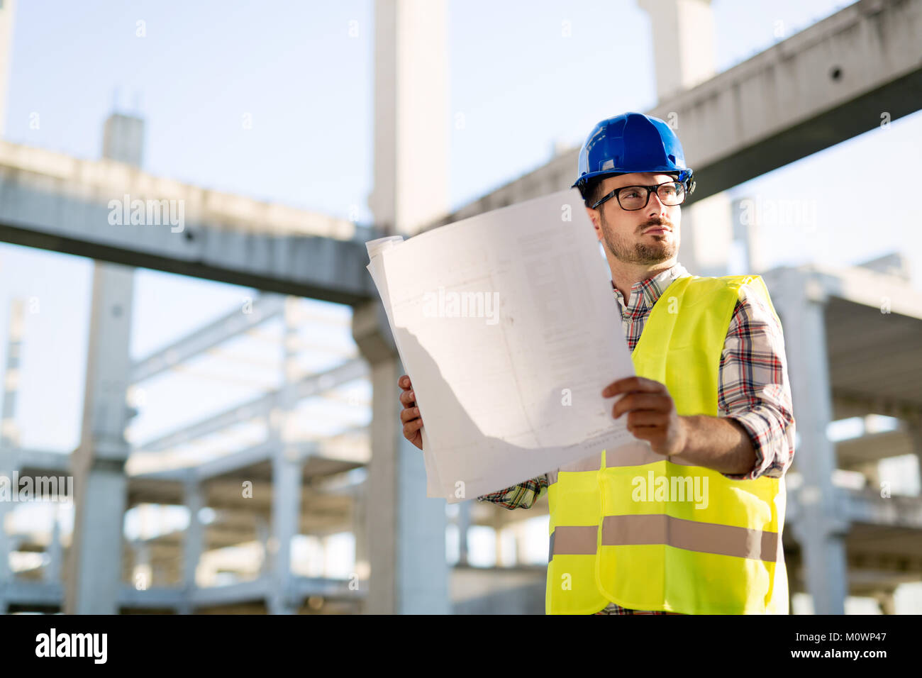 Picture of construction site engineer looking at plan Stock Photo - Alamy