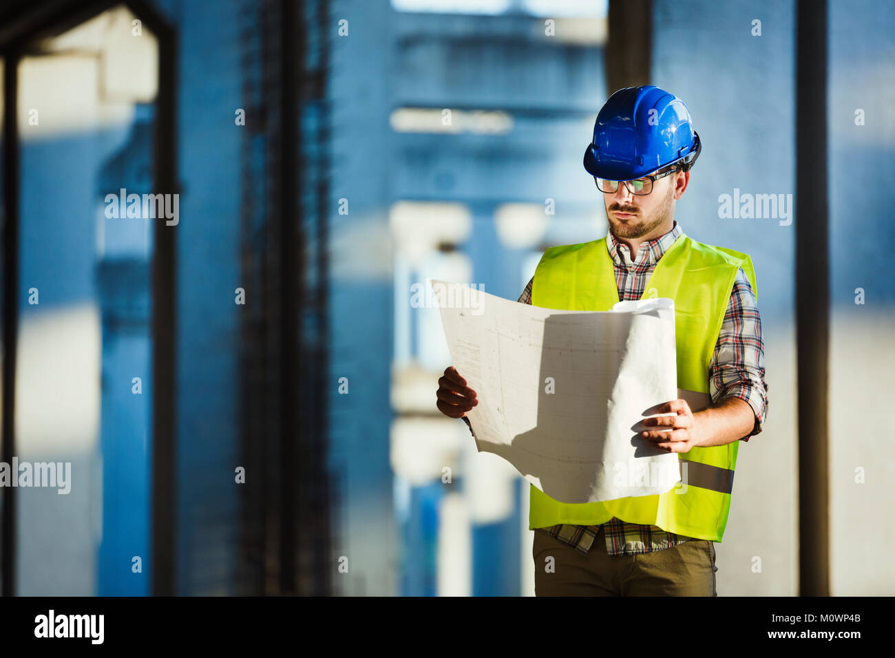 Picture of construction site engineer looking at plan Stock Photo - Alamy