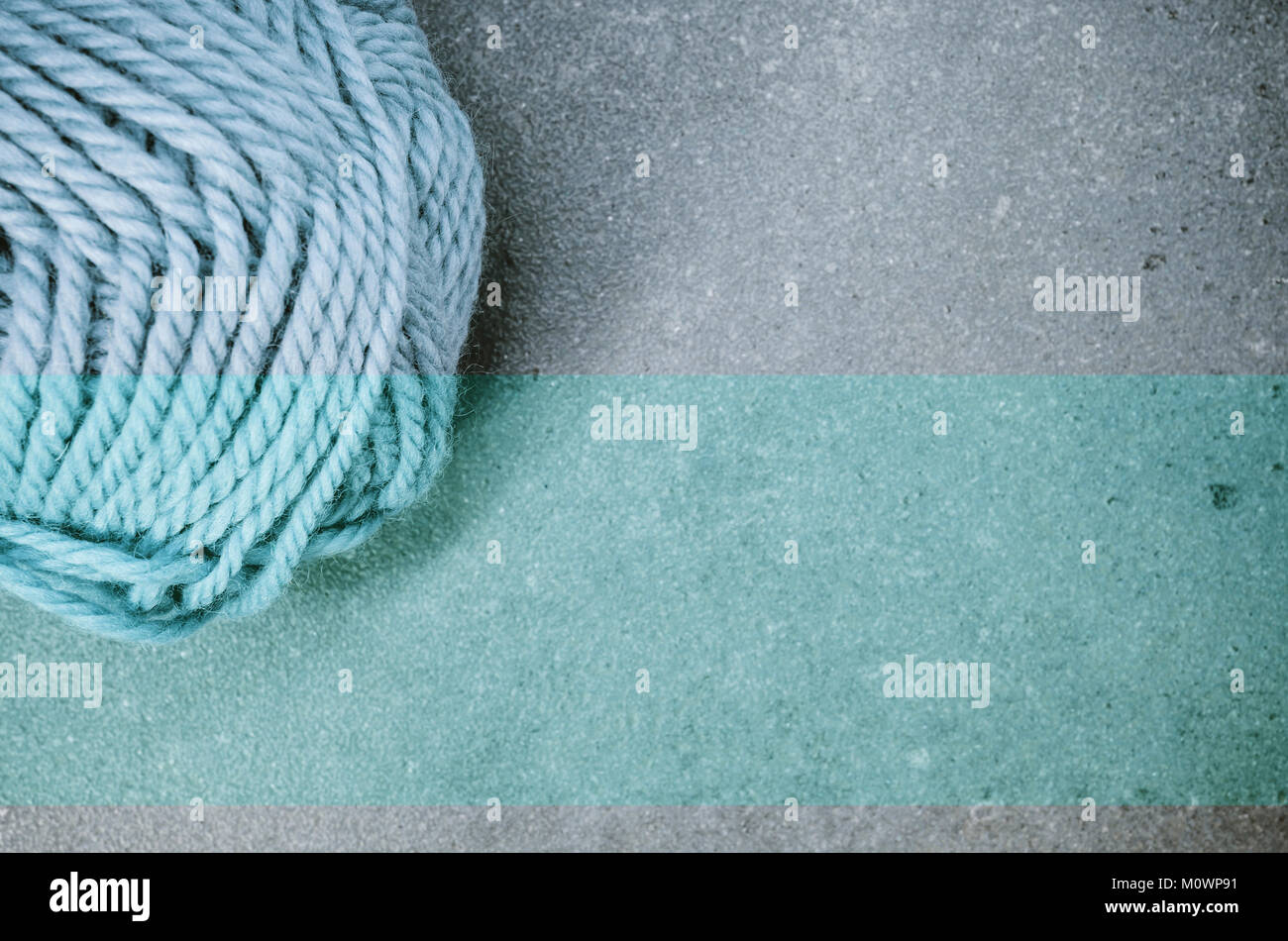 ball of light blue wool yarn on a rough stone surface - copy space ...