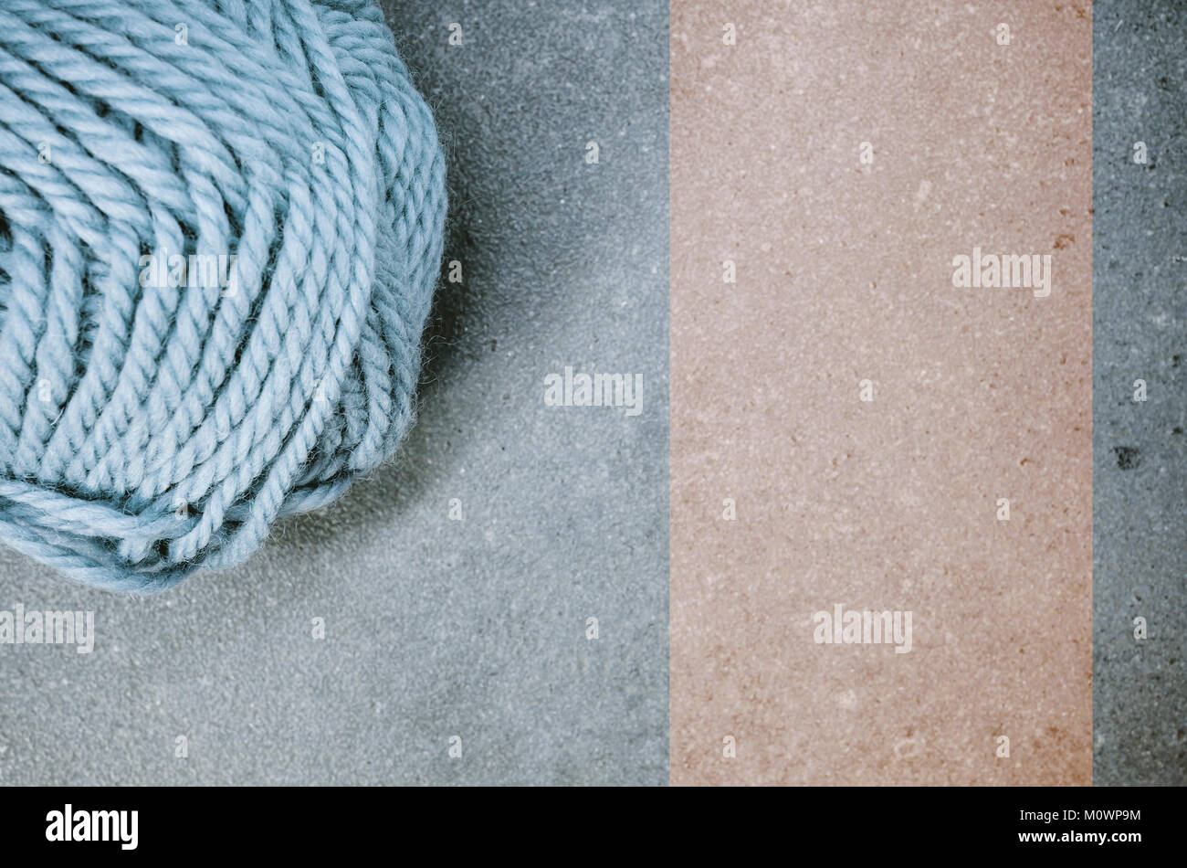 ball of light blue wool yarn on a rough stone surface - copy space ...