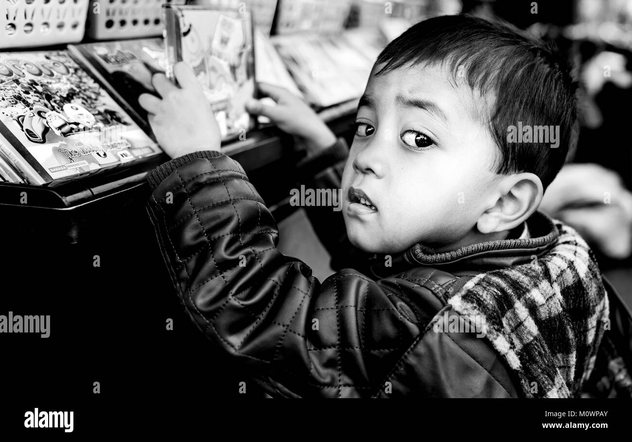 Little boy working in a shop inside a small market, Indonesia Stock ...