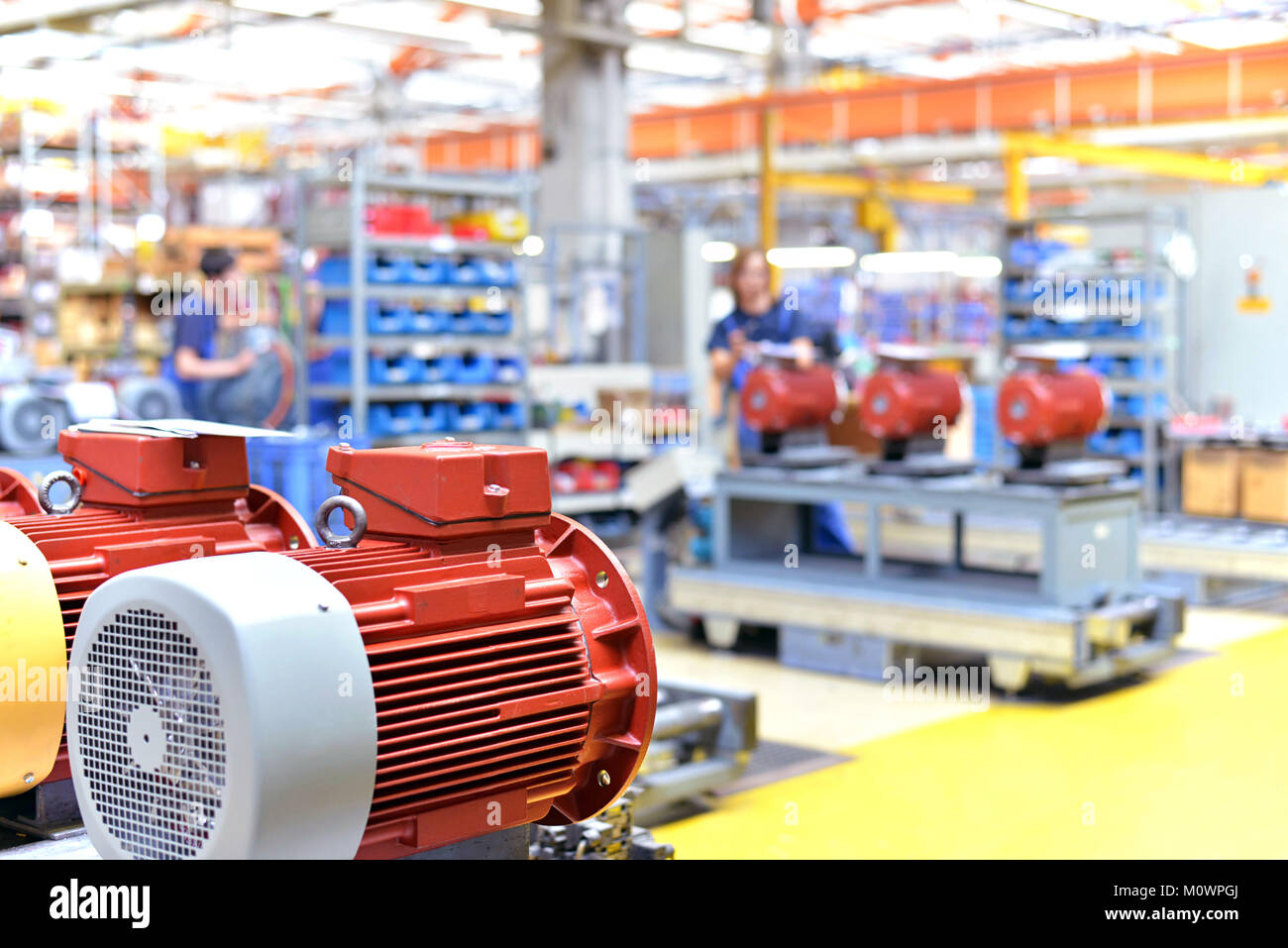 mechanical engineering: closeup of electric motors in production in a ...