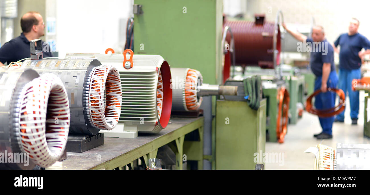Workers in a factory assemble electric motors Stock Photo - Alamy