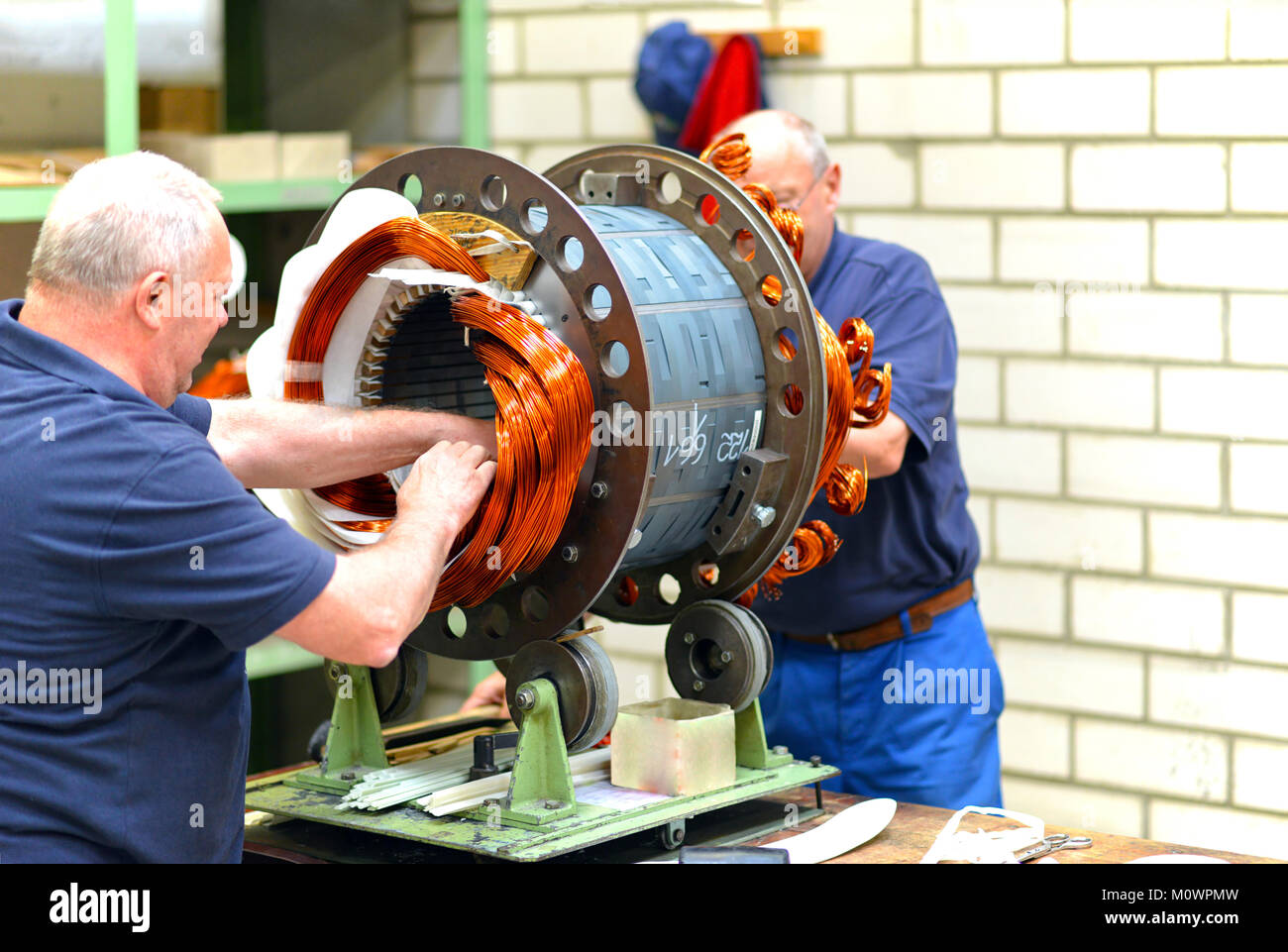Workers in a factory assemble electric motors Stock Photo - Alamy
