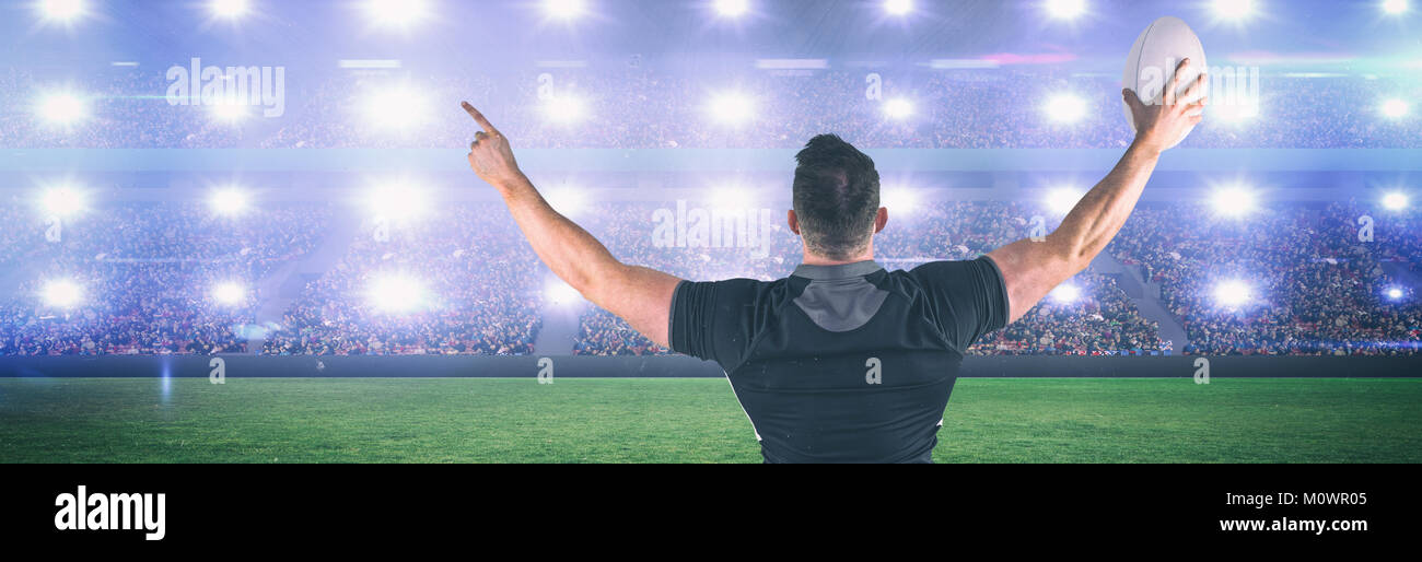 Composite image of rugby player celebrating with the ball Stock Photo ...