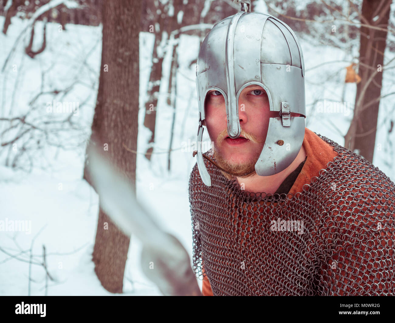 Medieval Irish warrior in chain mail and helmet holds a spear in the ...