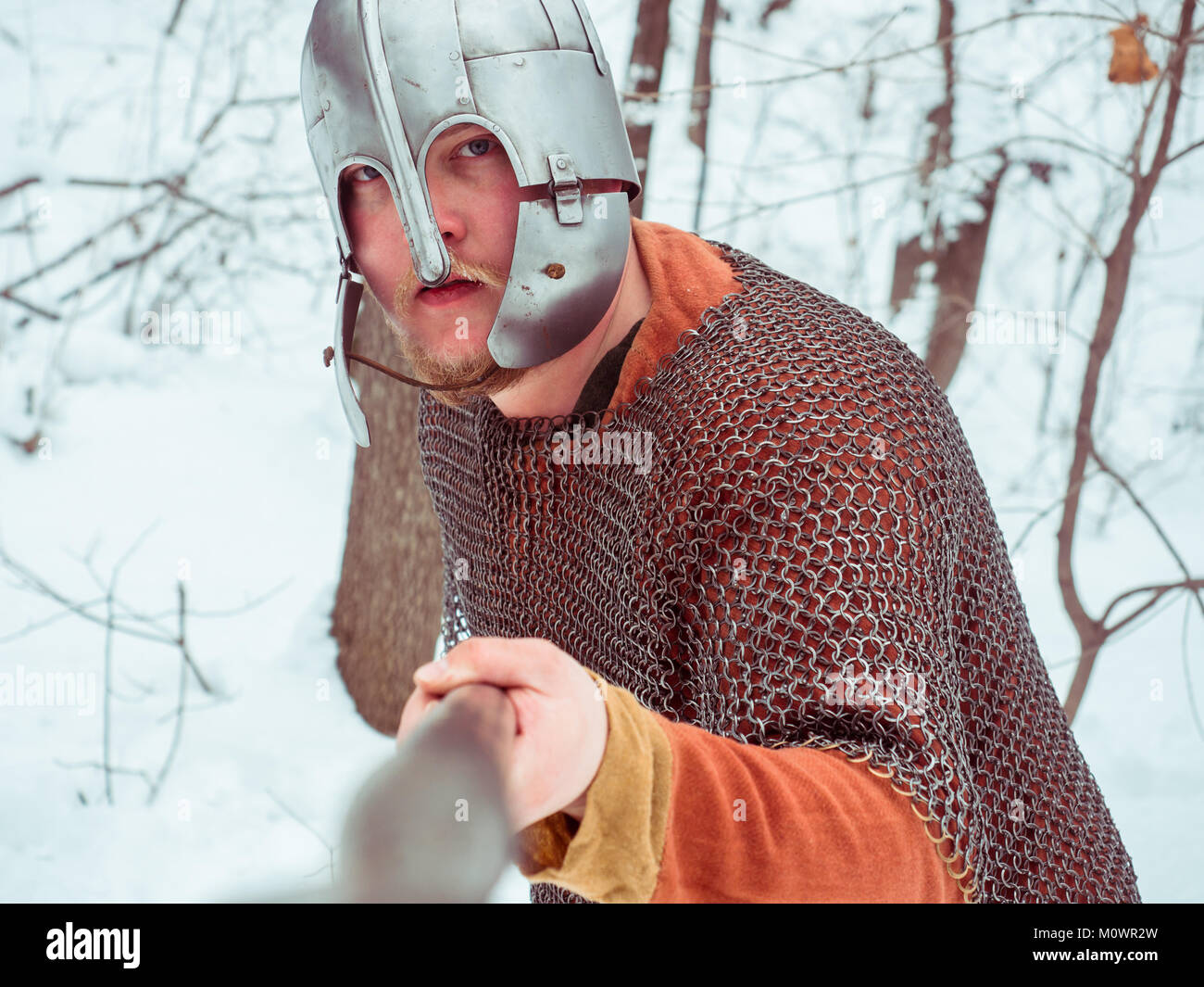 Medieval Irish warrior in chain mail and helmet holds a spear in the ...