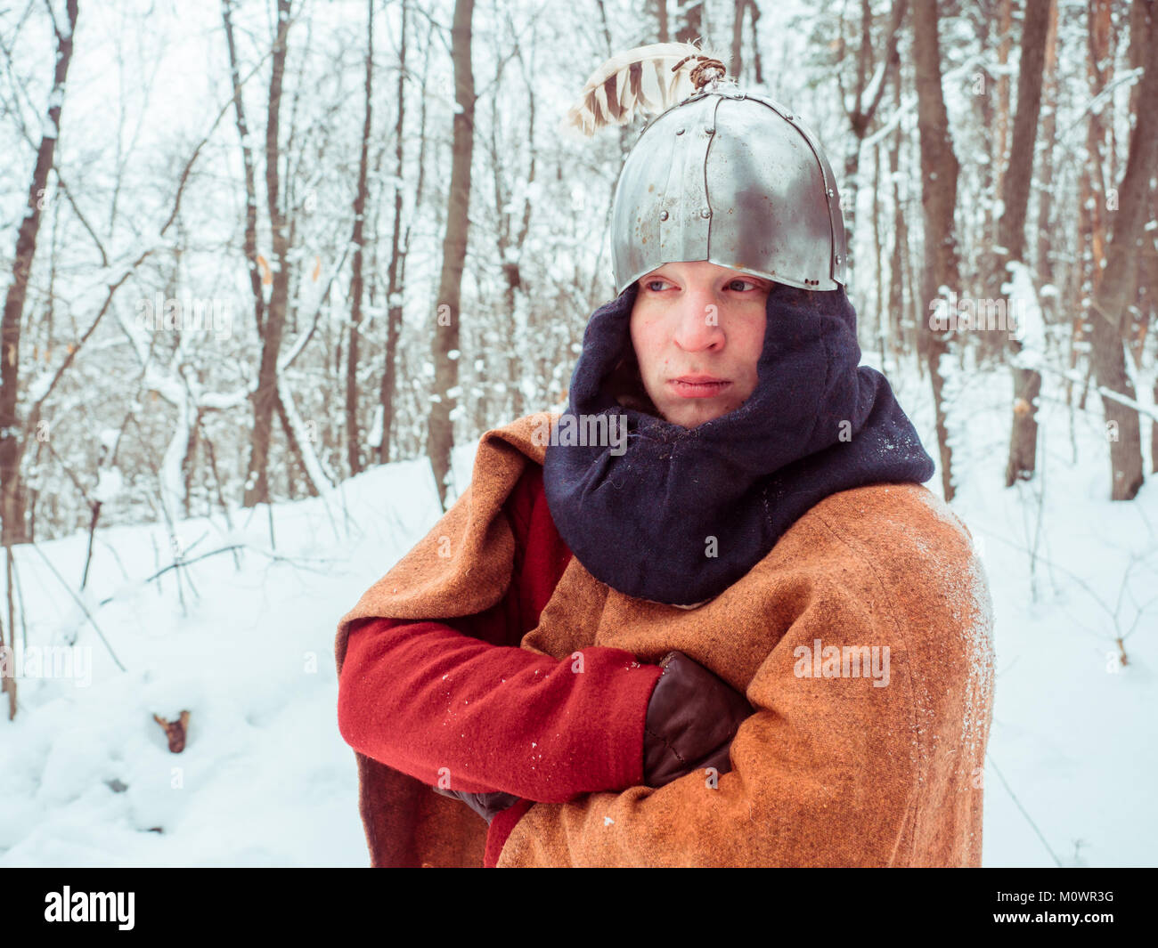 Frankish warrior in historical costume with helmet in winter forest ...