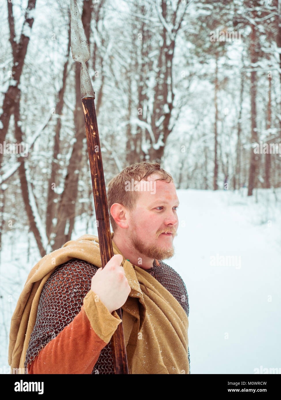 Medieval Irish warrior in chain mail and helmet holds a spear in the ...