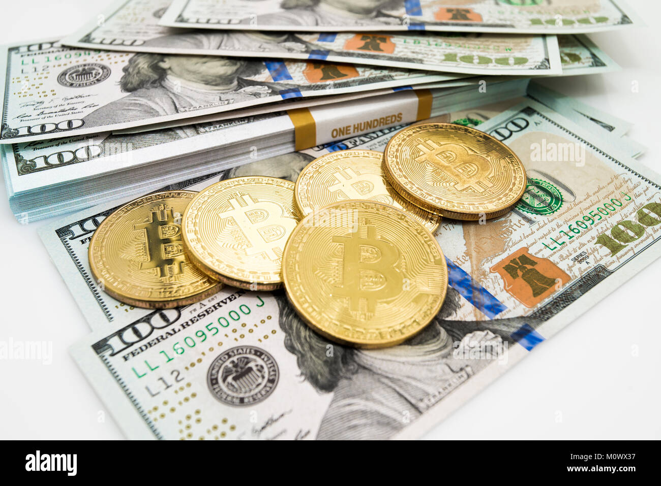 Physical version of Bitcoin and banknotes of dollar isolated on white ...