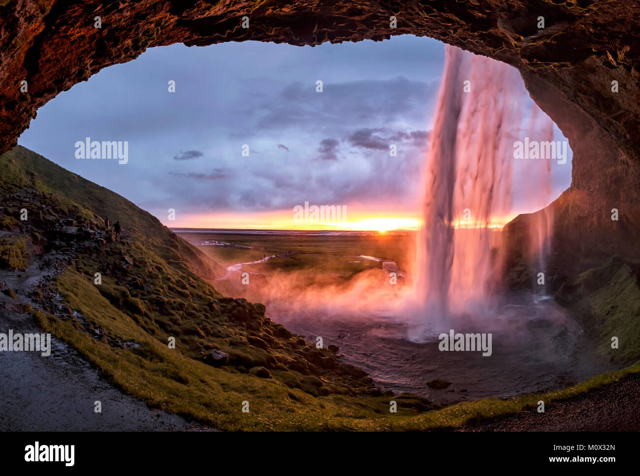 Sunset through Waterfall Stock Photo - Alamy