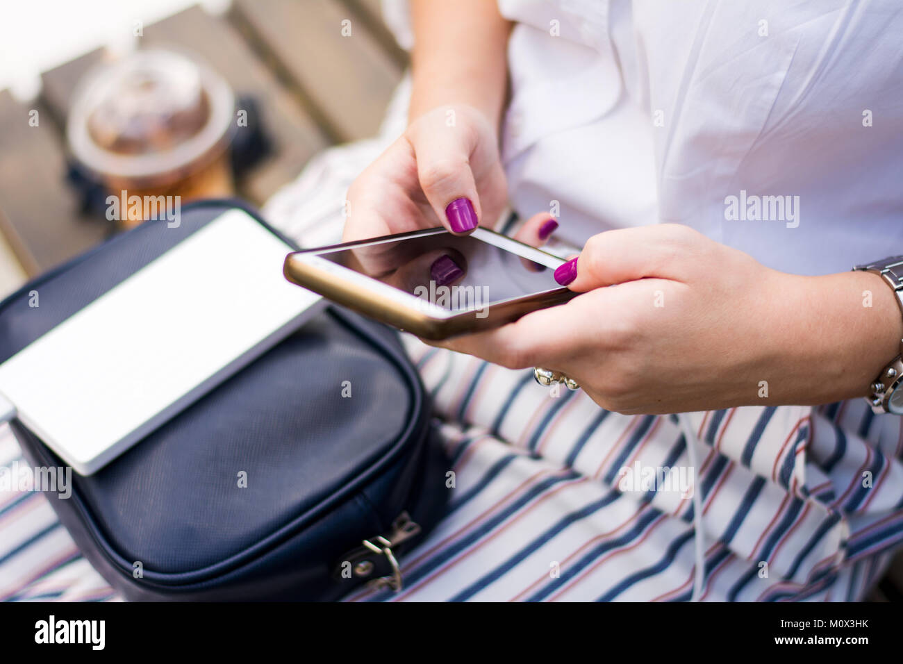 Girl using smart phone while charging on the power bank Stock Photo - Alamy