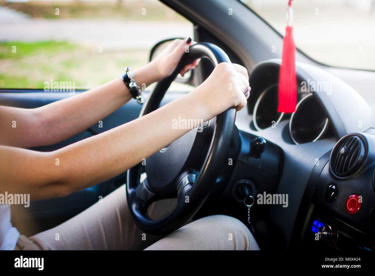 Fashionable female driver in a car Stock Photo - Alamy