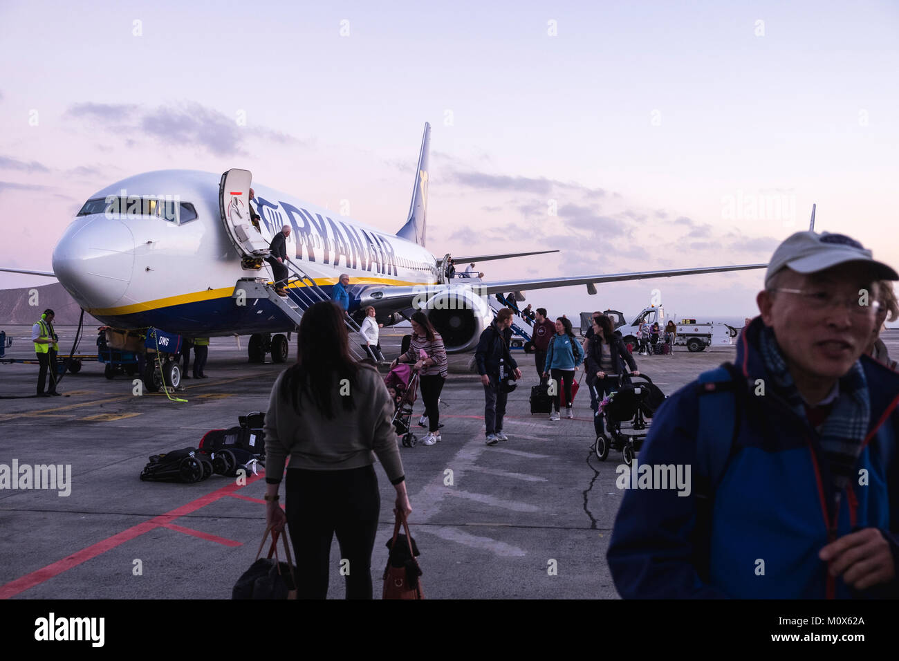 Passengers disembarking a Ryanair flight by the front steps on the ...