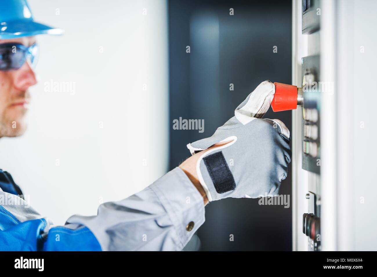 Emergency Machine Stop Button. Caucasian Engineer Testing Red Emergency ...