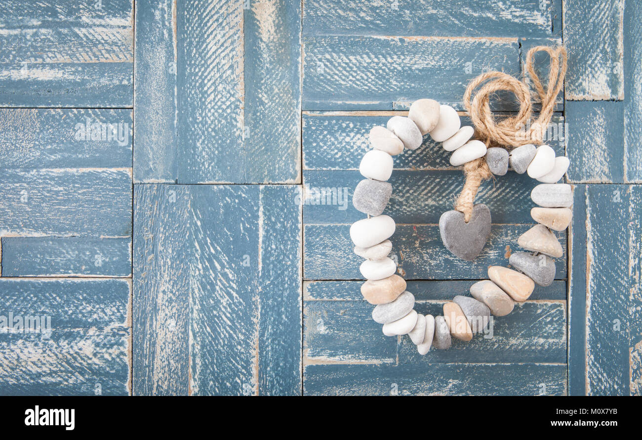 Heart made from pebbles on blue wooden background Stock Photo - Alamy
