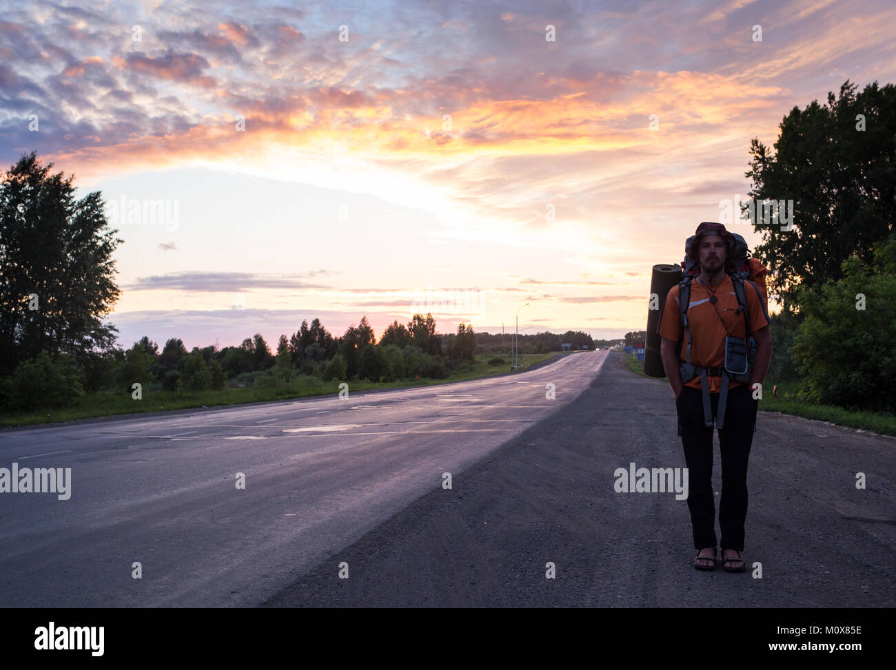 Woman hitchhiking on desert road hi-res stock photography and images ...