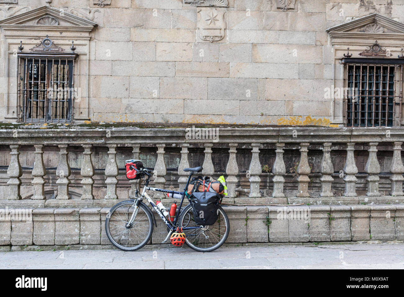 Pilgrim bike resting in balustrade stone, historic center of Santiago ...