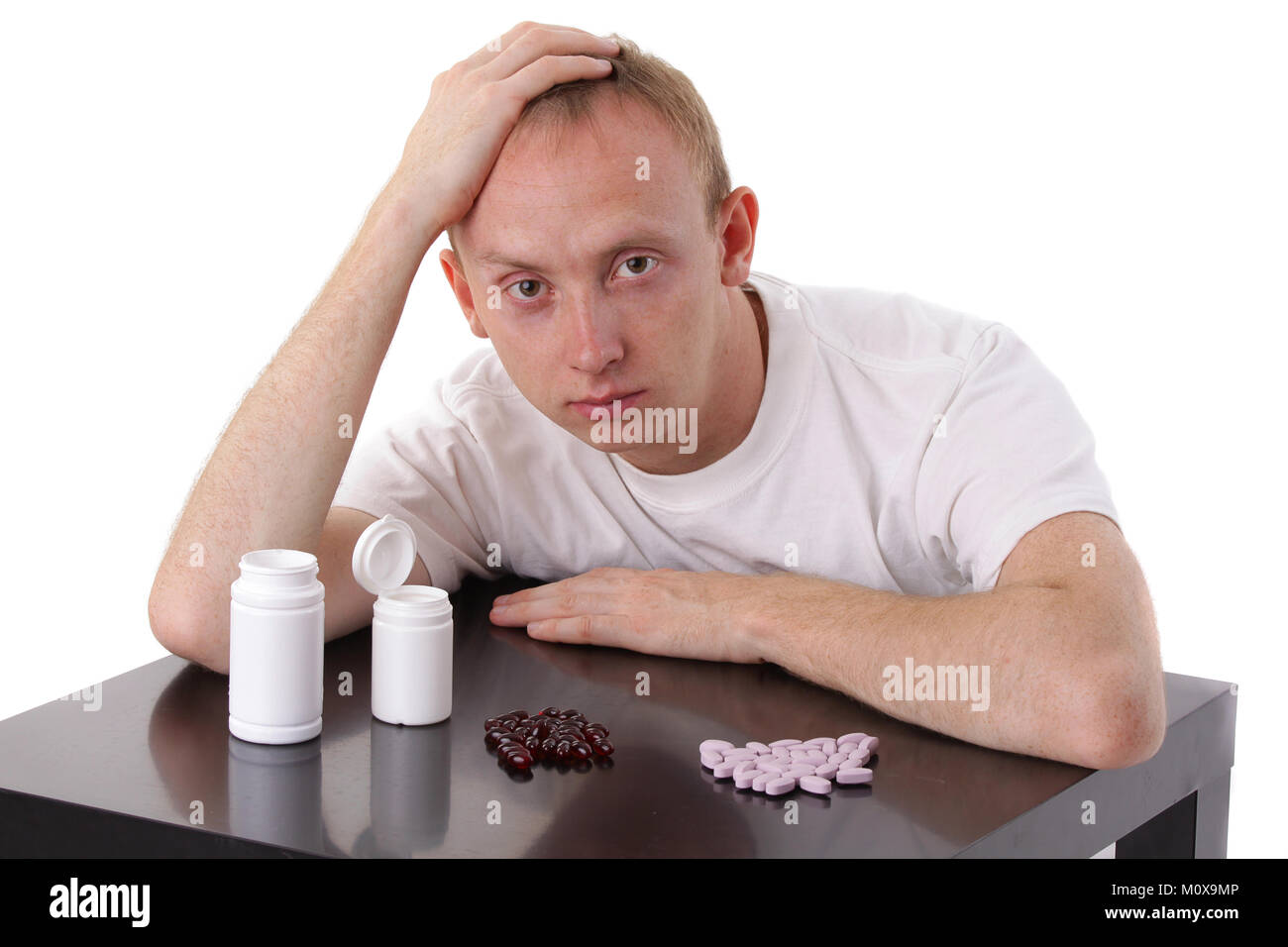 Man and pills isolated on white Stock Photo - Alamy