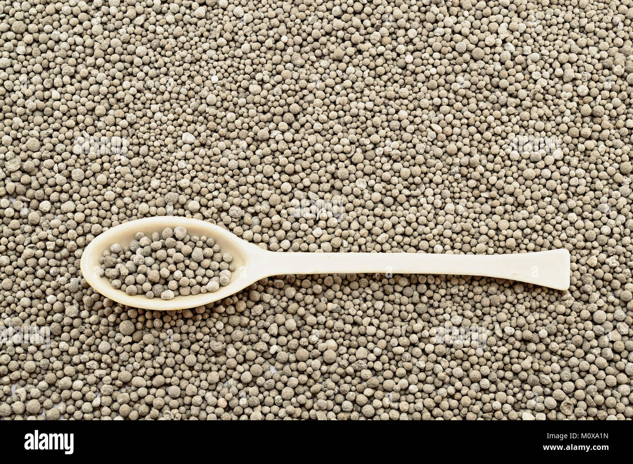 Porcelain laboratory spoon on composite mineral fertilizers Stock Photo ...