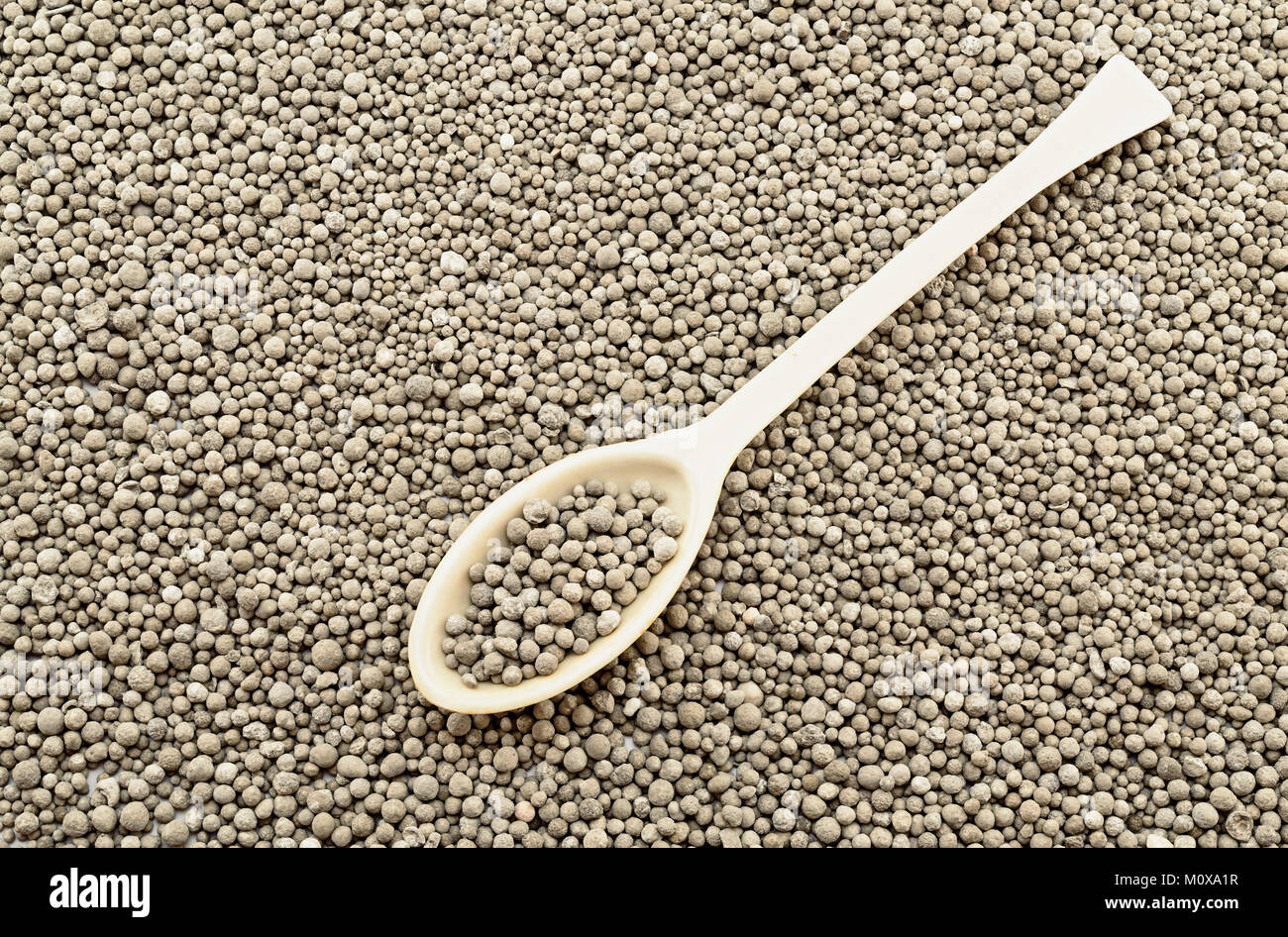 Porcelain laboratory spoon on composite mineral fertilizers Stock Photo ...
