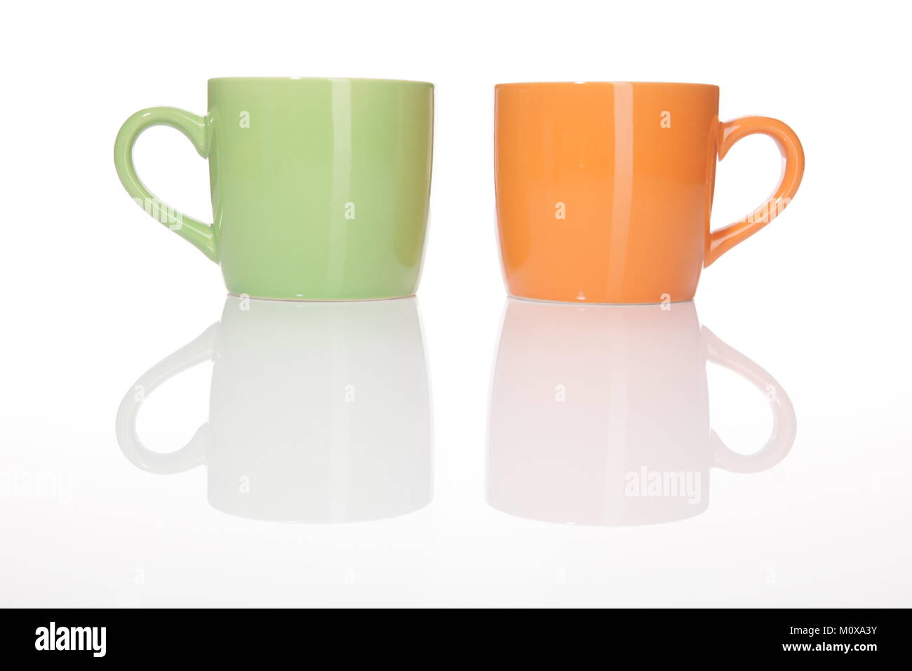 two cups standing on white background Stock Photo - Alamy